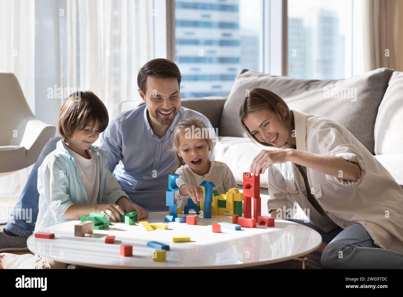 Happy family with kids playing wooden blocks at modern home Stock Photo ...