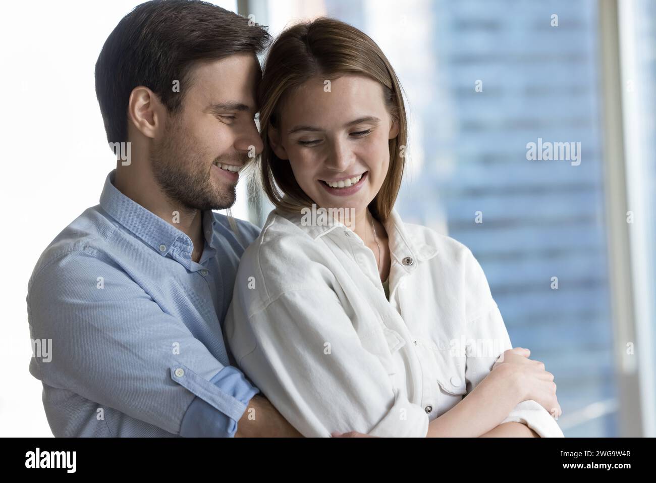 Close up beautiful loving couple hugging standing indoor Stock Photo ...