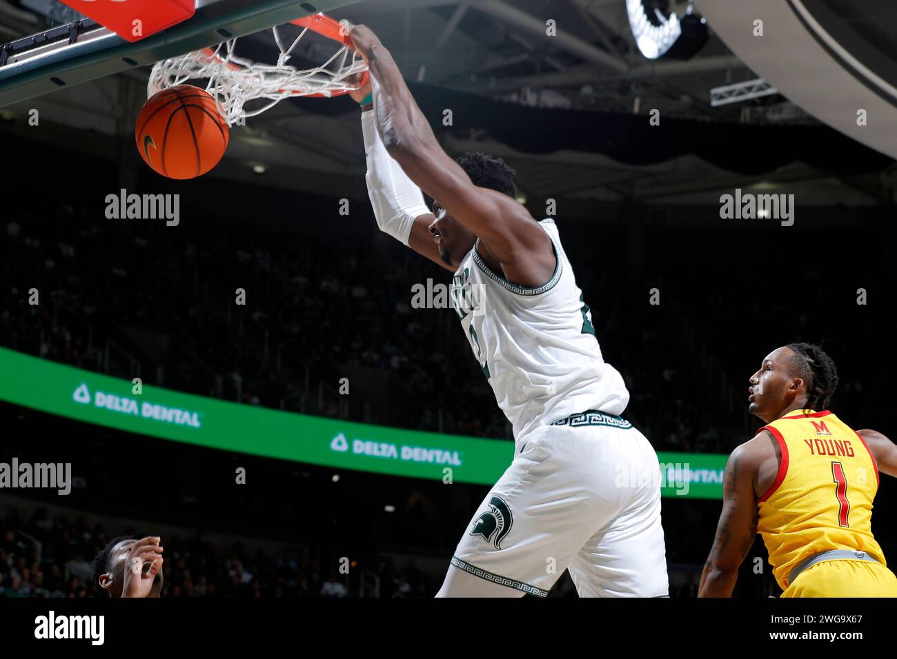 Michigan State center Mady Sissoko, left, dunks against Maryland guard ...