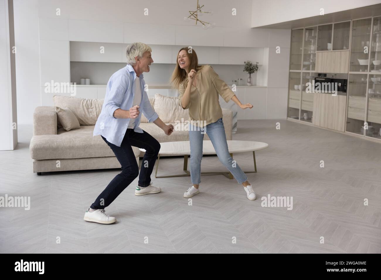 Excited active old retired dad and adult daughter enjoying movement ...