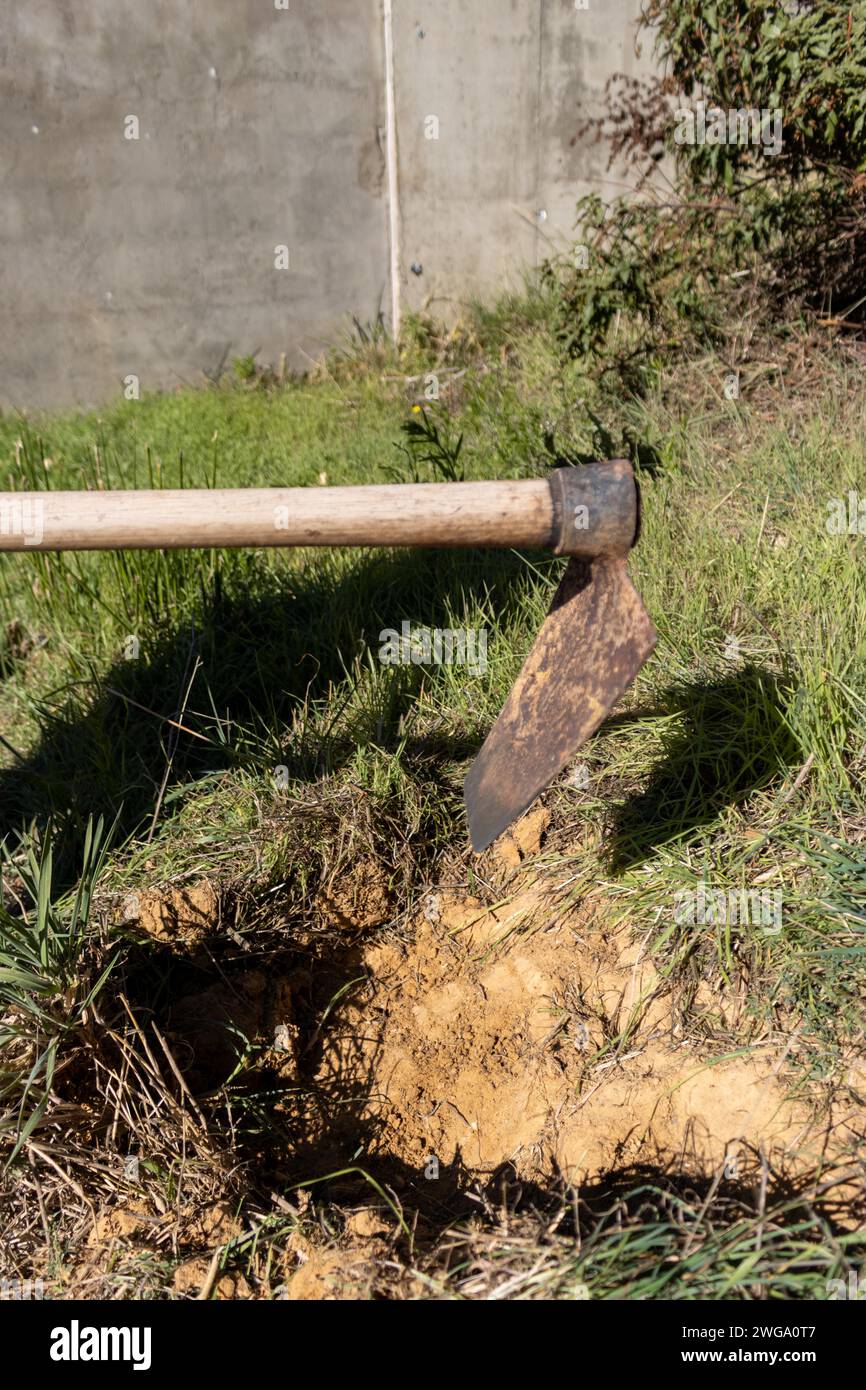 Vertical detail of a hoe digging and lifting up the soil Stock Photo ...