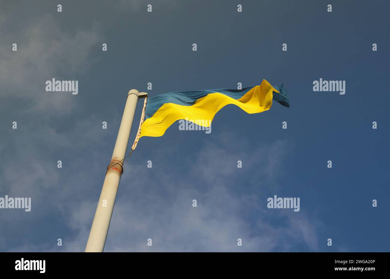 Ukraine flag large national symbol fluttering in blue sky. Large yellow ...