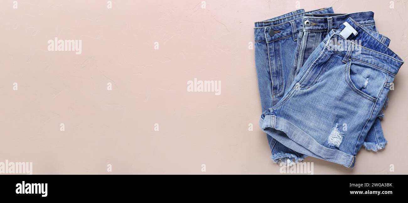 Stylish denim shorts on beige background with space for text, top view ...