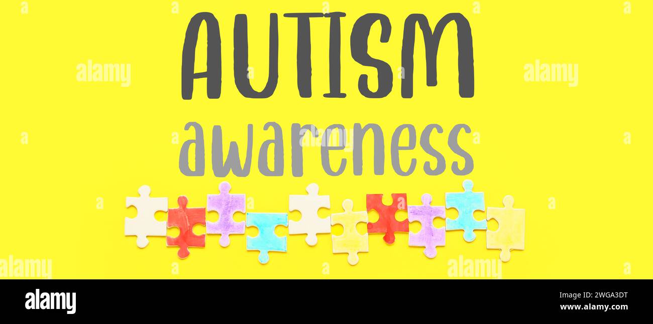 Colorful puzzle pieces and text AUTISM AWARENESS on yellow background ...