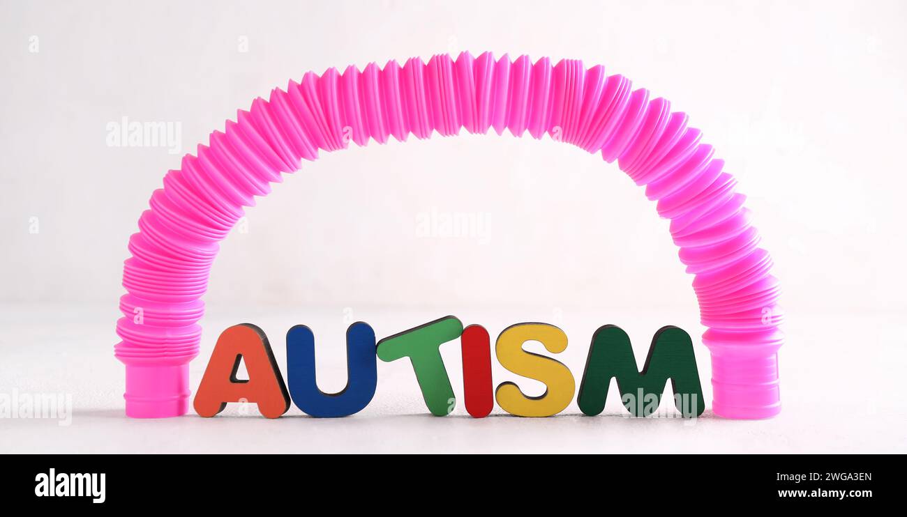 Word AUTISM and Pop Tube on white background Stock Photo - Alamy