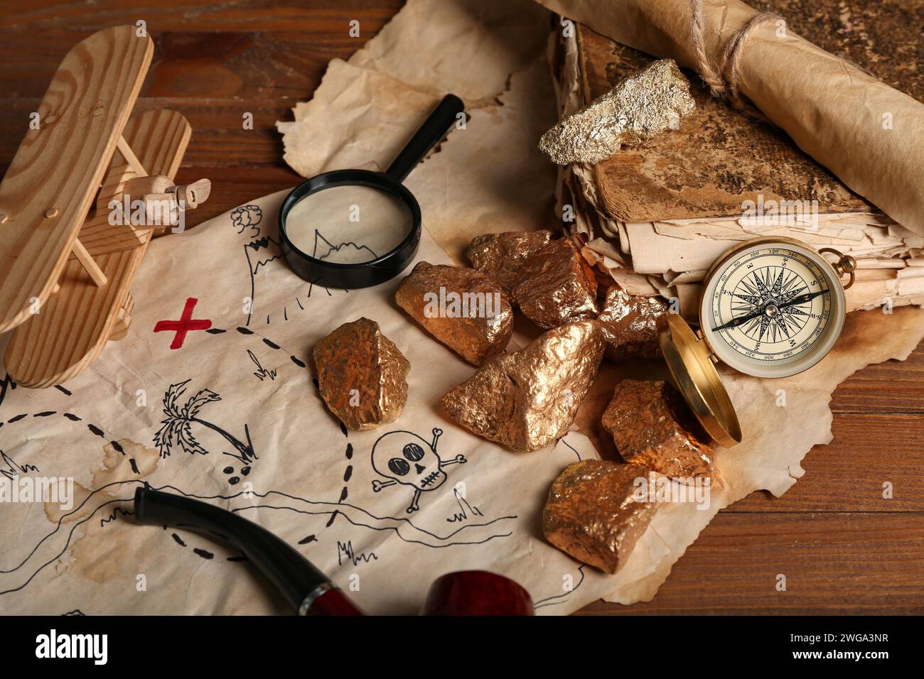 Treasure map with travel equipment and golden nuggets on brown wooden ...