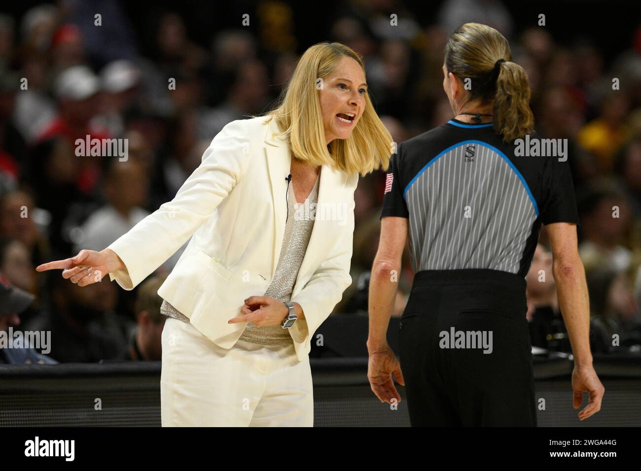 Maryland head coach Brenda Frese, left, talks with an official, right ...