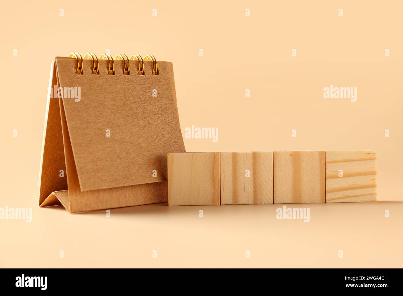 Wooden cubes with blank flip calendar on beige background Stock Photo ...