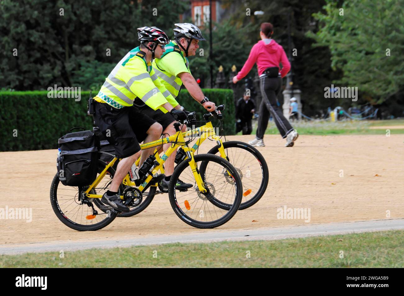 Two policemen on a bicycle, bicycle patrol, on the way in Hyde Park ...
