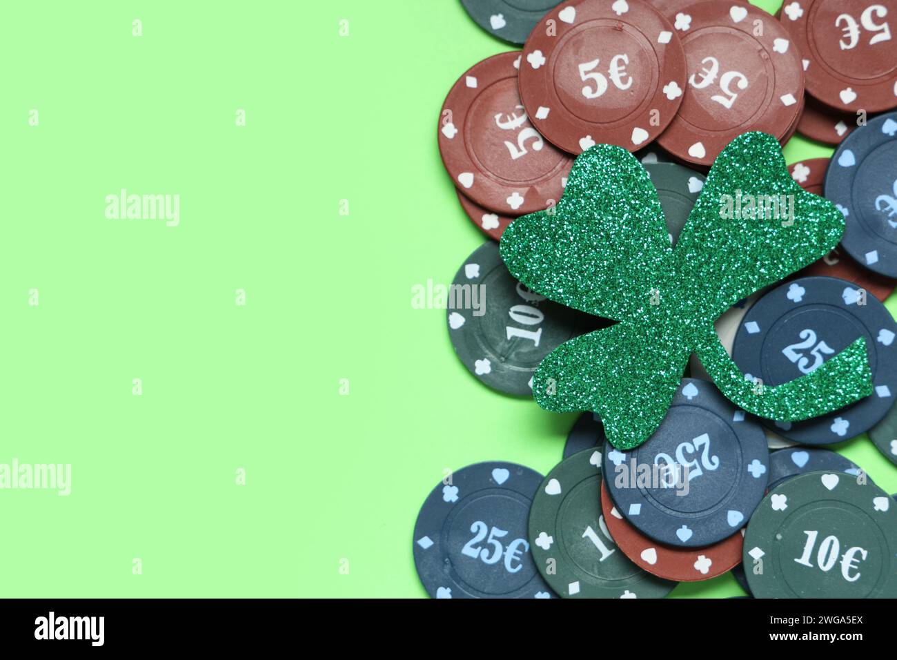 Lucky clover with poker chips on green background. St. Patrick's Day ...