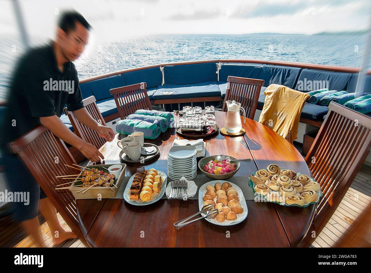Stewerd with snacks on dive liveaboard Pelagian, Wakatobi Dive Resort ...