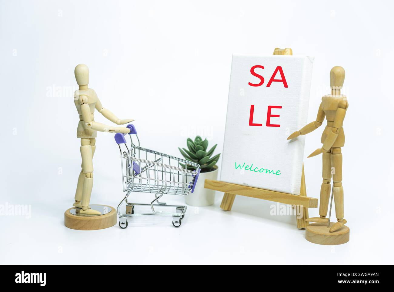 Mannequin drawing a SALE on easel; isolated on white background ...