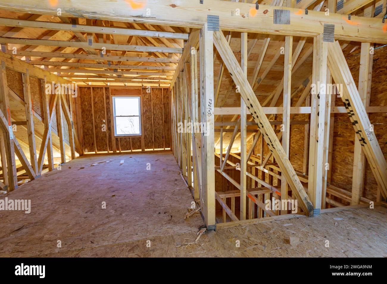 An unfinished house with wooden framing beams in construction work ...