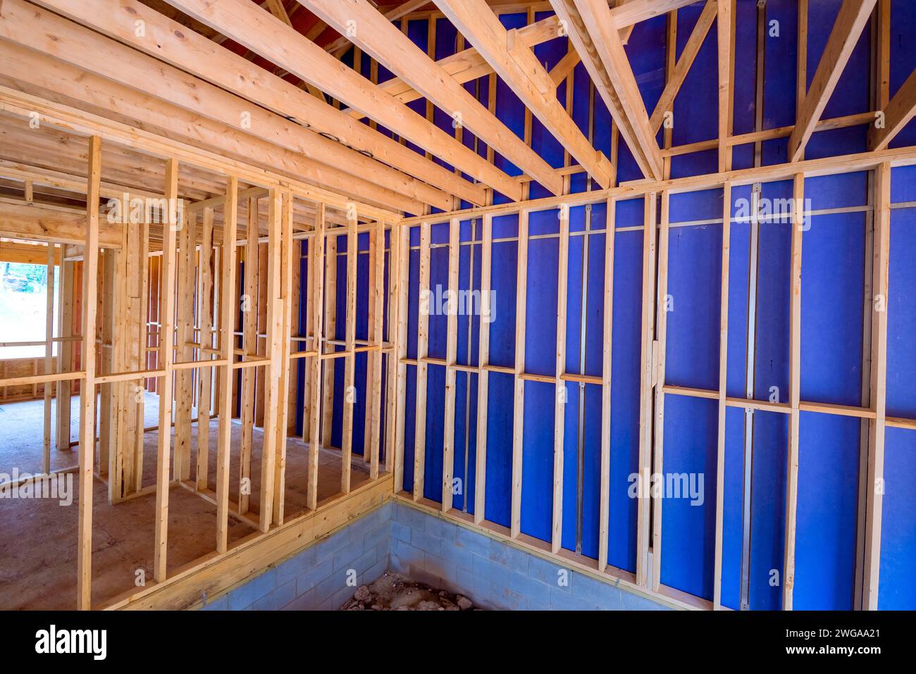 Construction during are assembling wooden beams to form framework of a house Stock Photo - Alamy