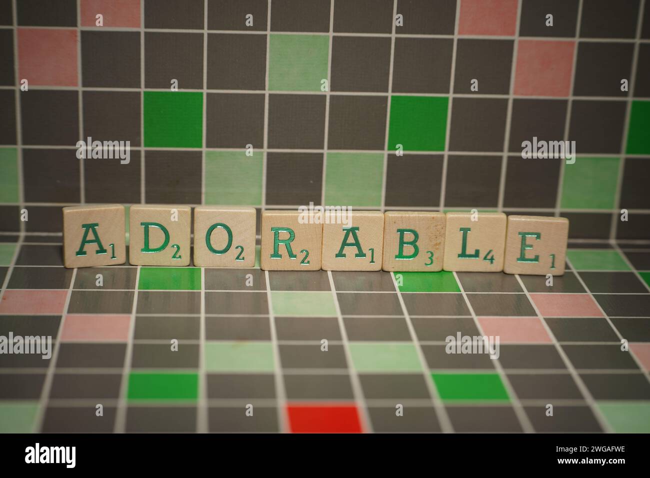 Wooden tile with green adorable text on a blocked background Stock ...