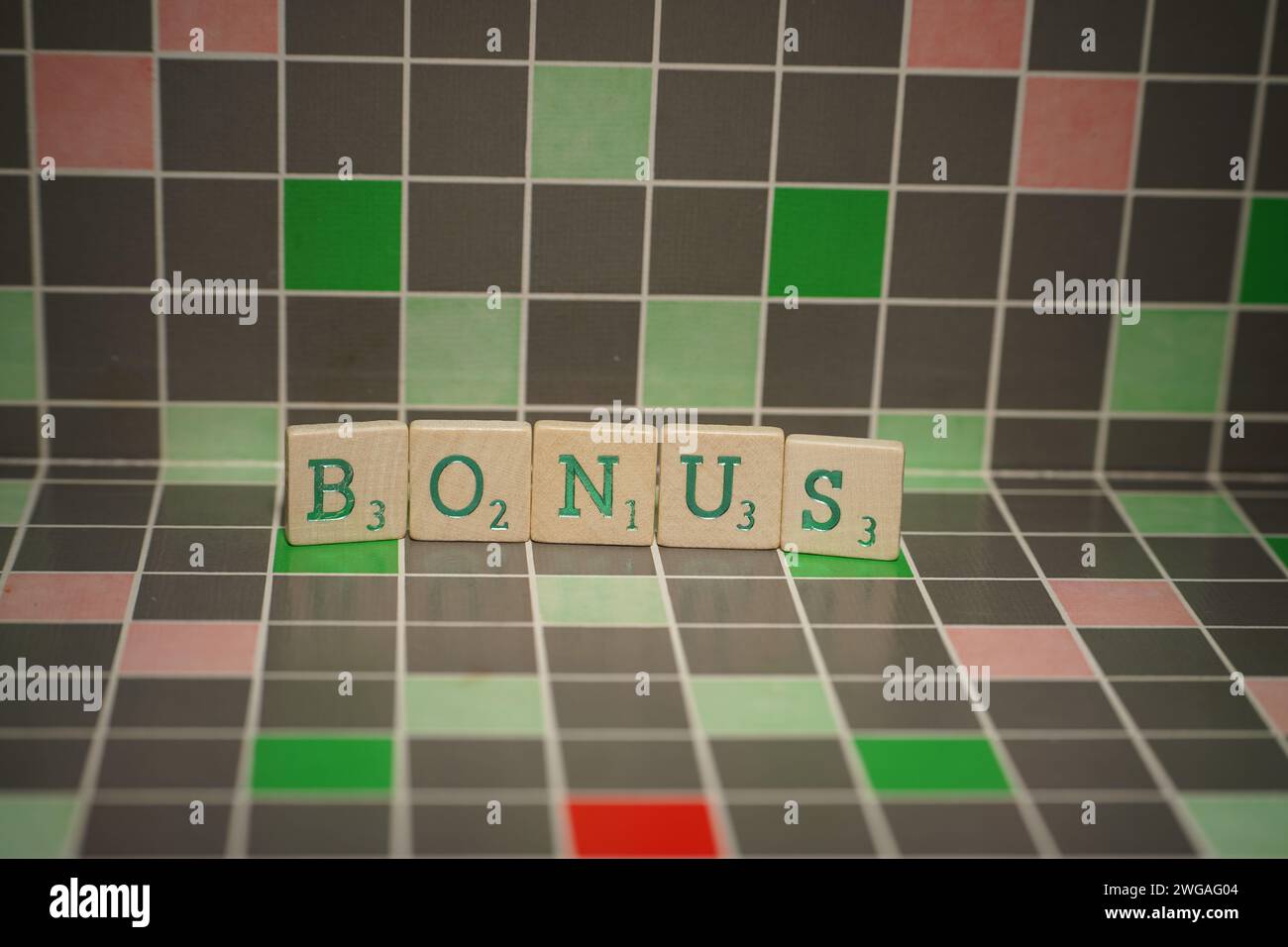 Wooden tile with green bonus text on a blocked background Stock Photo ...