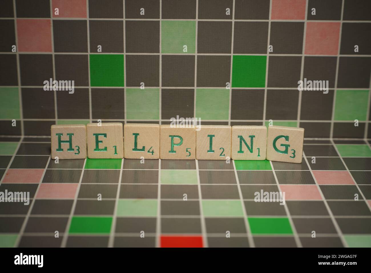 Wooden tile with green helping text on a blocked background Stock Photo ...