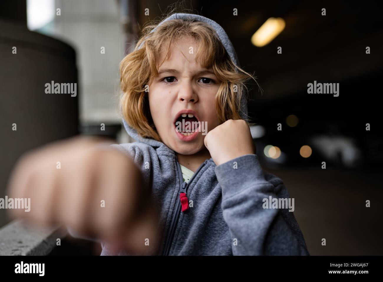 Aggressive child. Aggression kid boy fighting on street. Angry ...