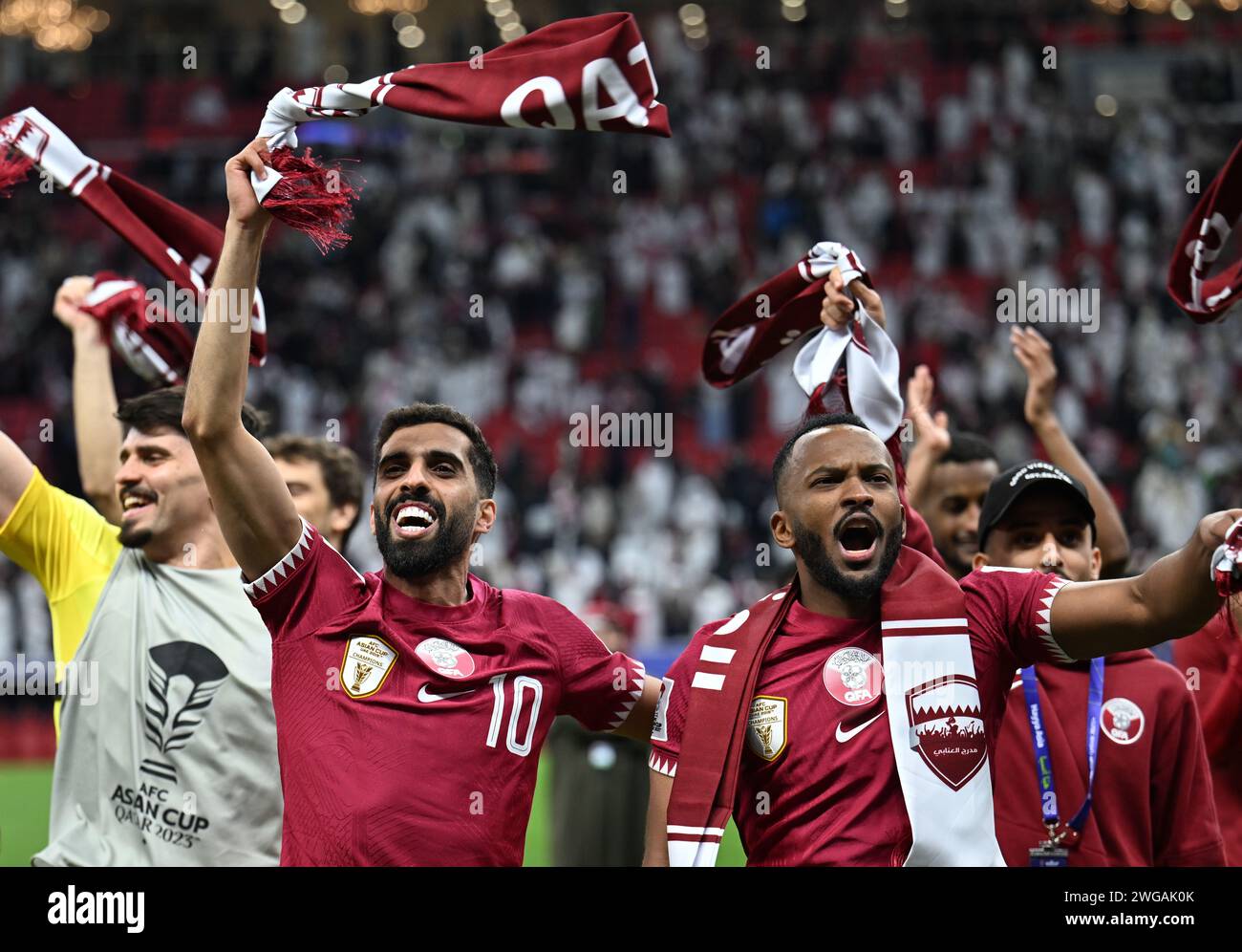 Doha, Qatar. 3rd Feb, 2024. Hasan Al Haydos (2nd L) of Qatar celebrates ...