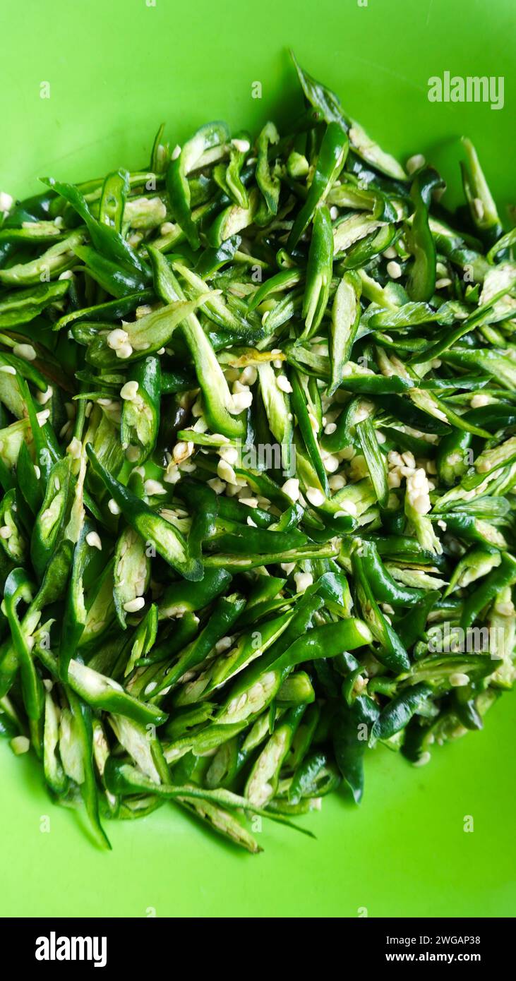 Chopped green chilies on a green plate Stock Photo - Alamy
