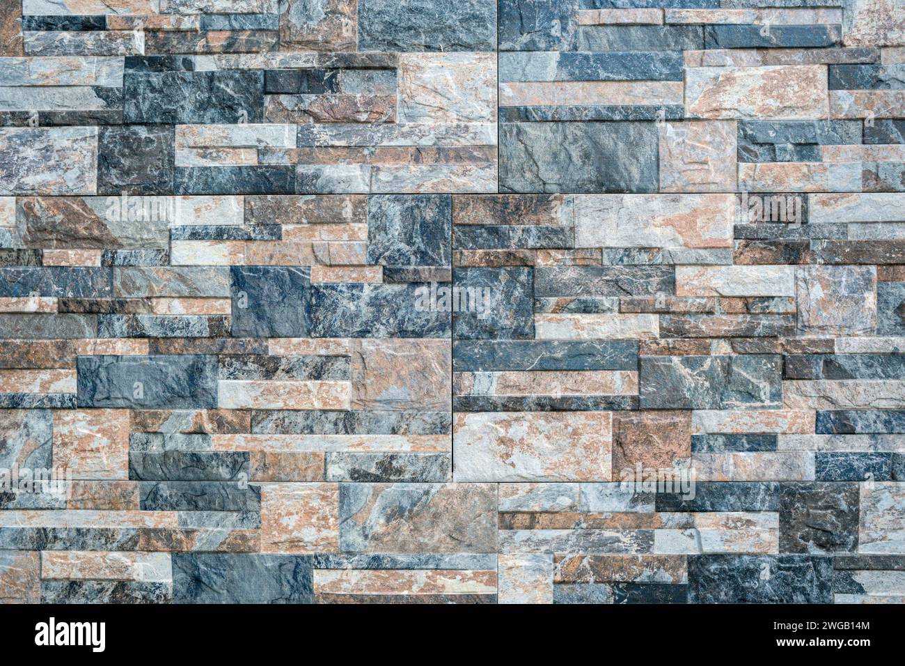 Background from a wall made of small stone tiles Stock Photo - Alamy