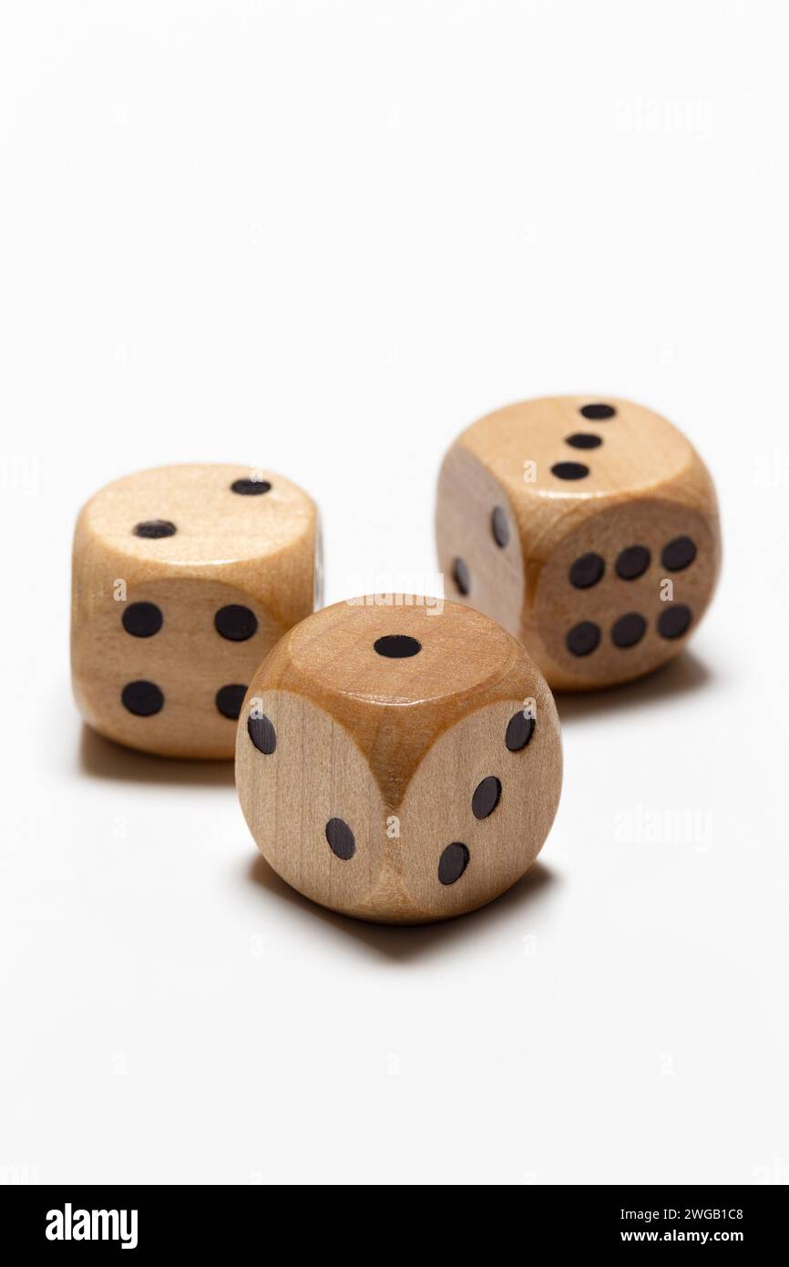 Three wooden dice on a white background close-up Stock Photo - Alamy