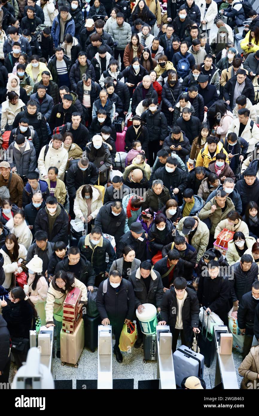 Passengers wait for their trains at Hangzhoudong railway station in ...