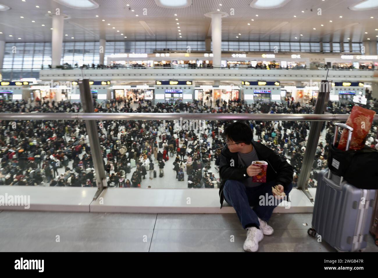 Passengers wait for their trains at Hangzhoudong railway station in ...