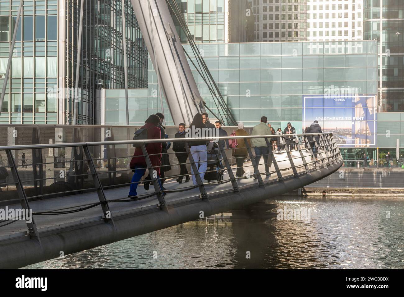 People walking across South Quay Footbridge from Isle of Dogs towards ...