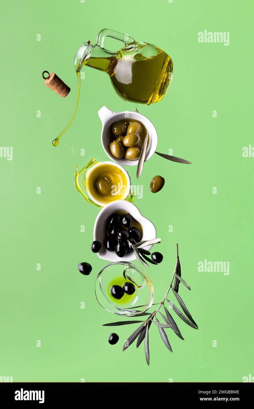 extra virgin olive oil and olives, composition in balance, still life ...