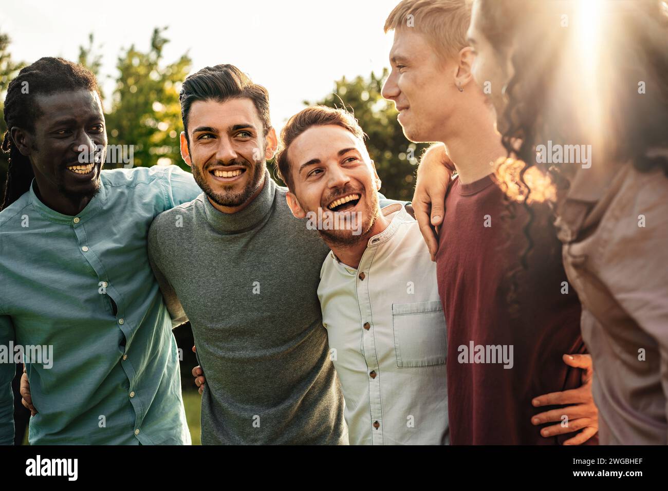 A group of joyful male friends bonding and laughing together in an ...