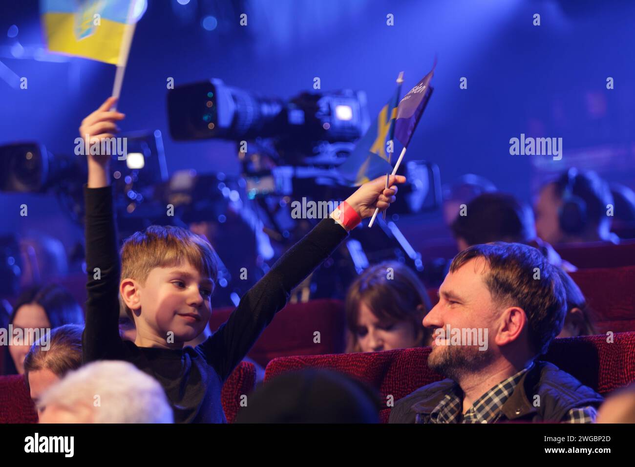 KYIV, UKRAINE - FEBRUARY 2, 2024 - A boy waves miniature flags during ...