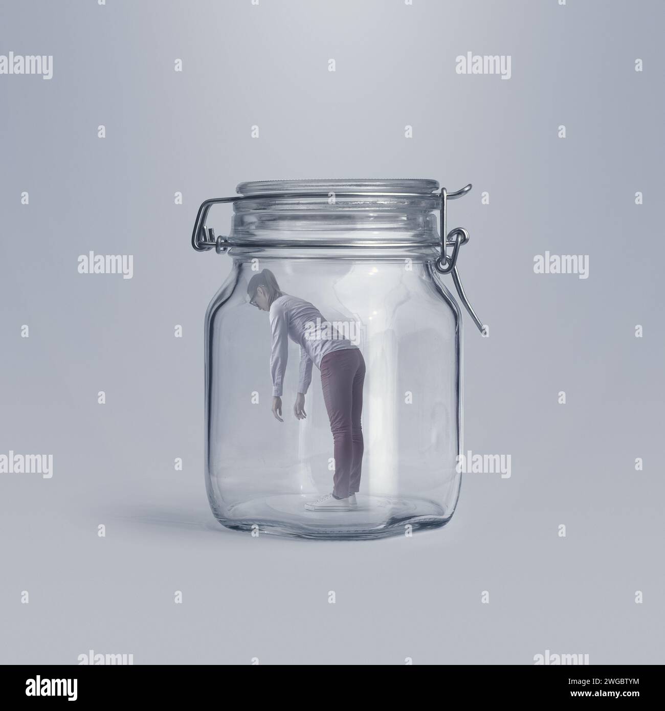 Scared young woman trapped in a huge glass jar, she is lonely and hopeless Stock Photo - Alamy
