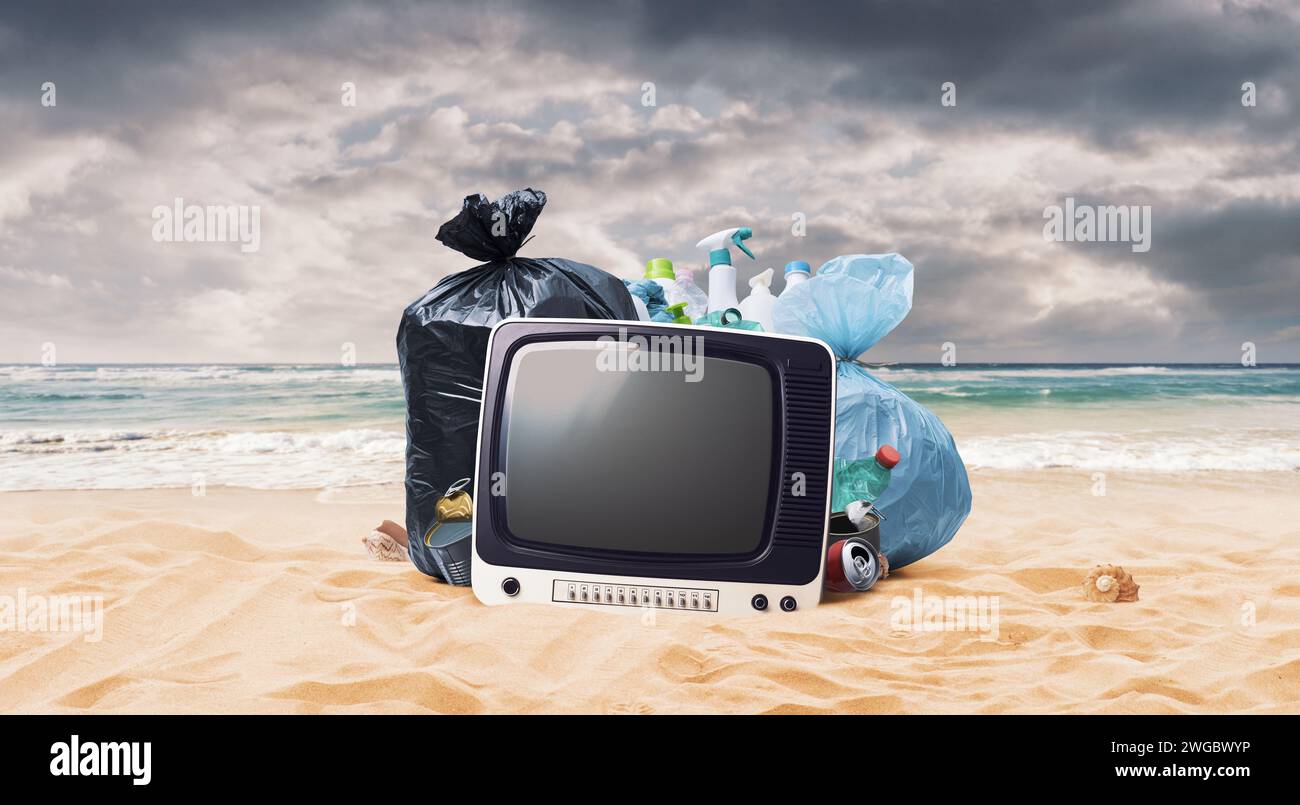 Assorted abandoned waste and old TV on the beach, environmental ...