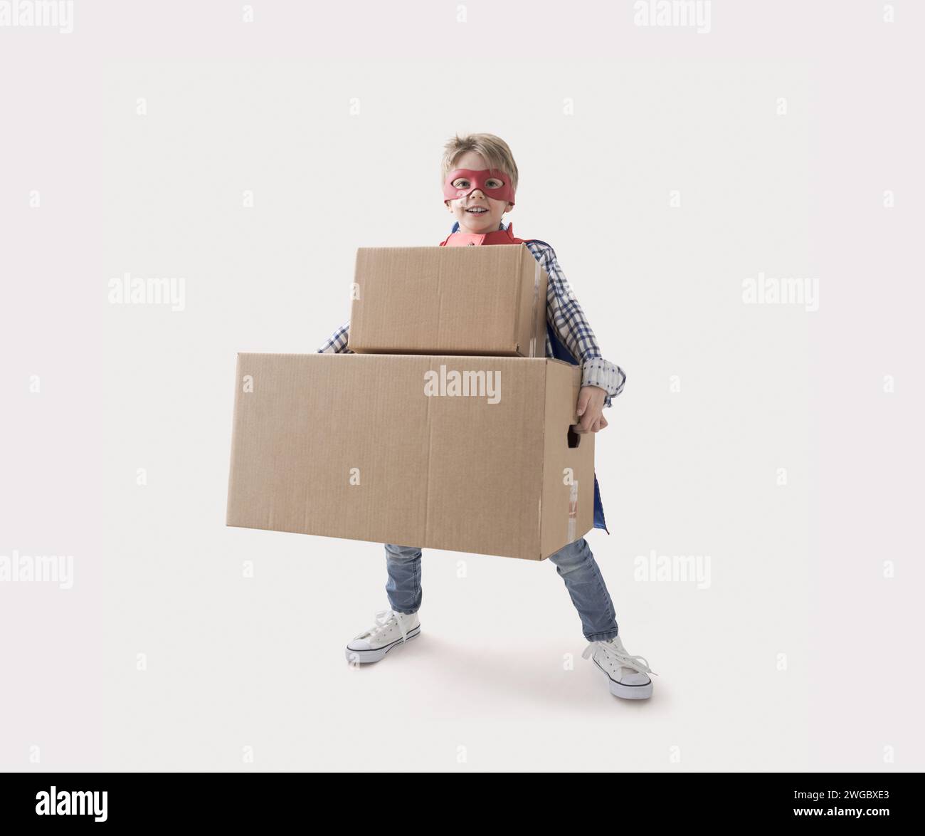 Cute superhero boy with mask and cape, he is carrying easily heavy ...