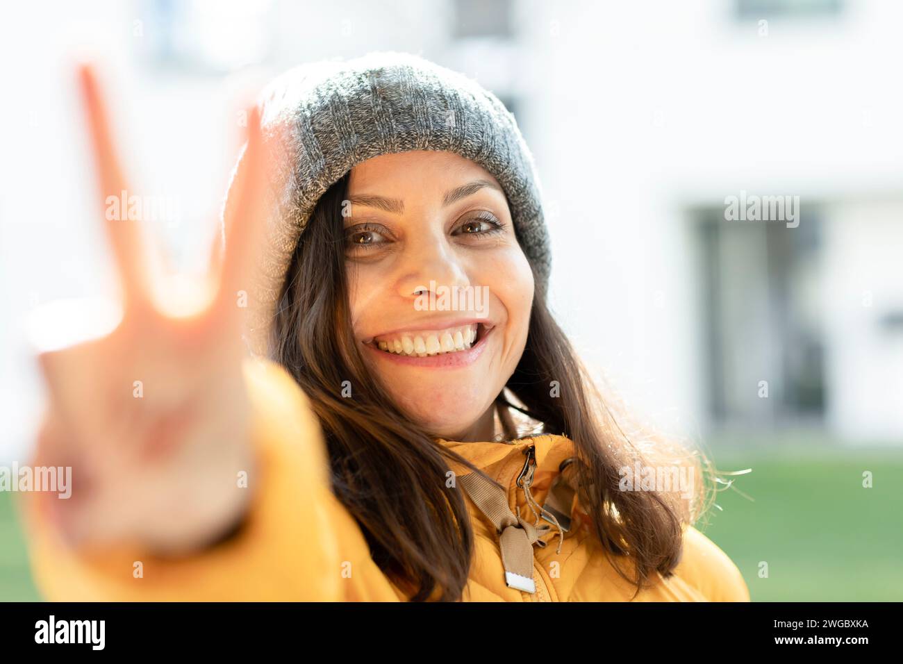 Portrait of a smiling woman standing in front of a residential district ...