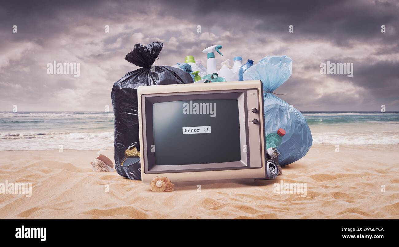 Abandoned waste and old computer monitor on the beach, environmental ...