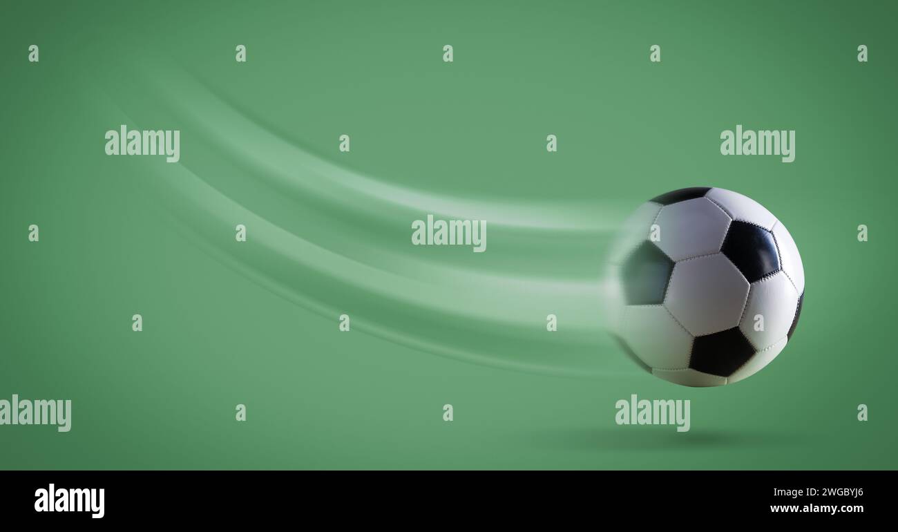 Fast soccer ball on green background, sports and championships concept ...