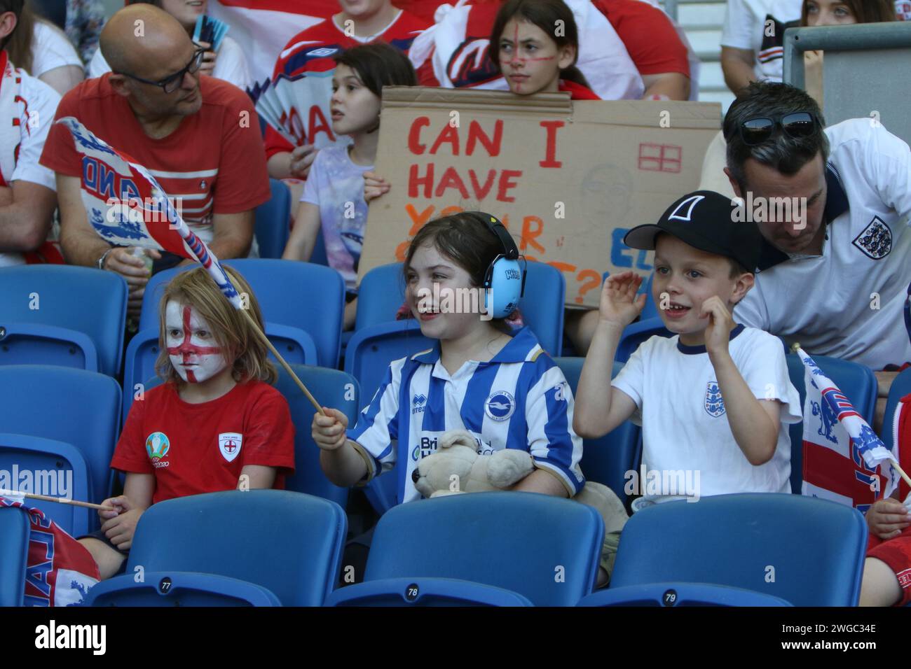 Girl in blue ear defenders and Brighton & Hove Albion shirt England v ...