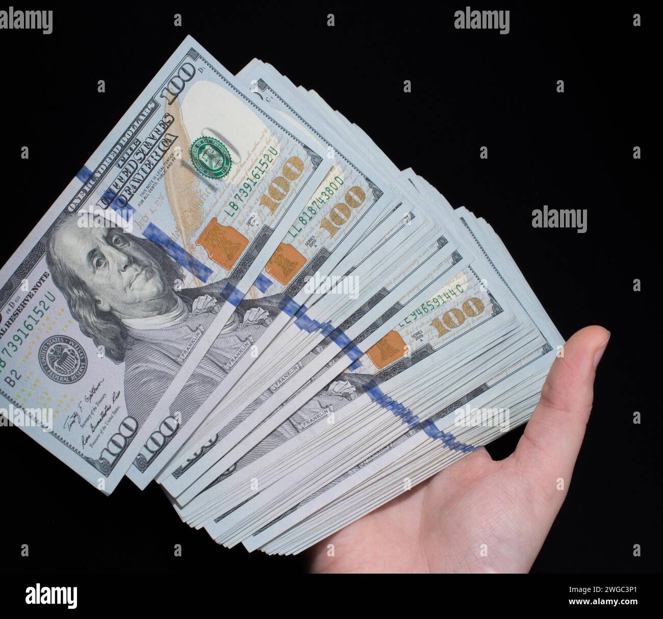 Hand holding American dollar banknotes isolated on white background ...