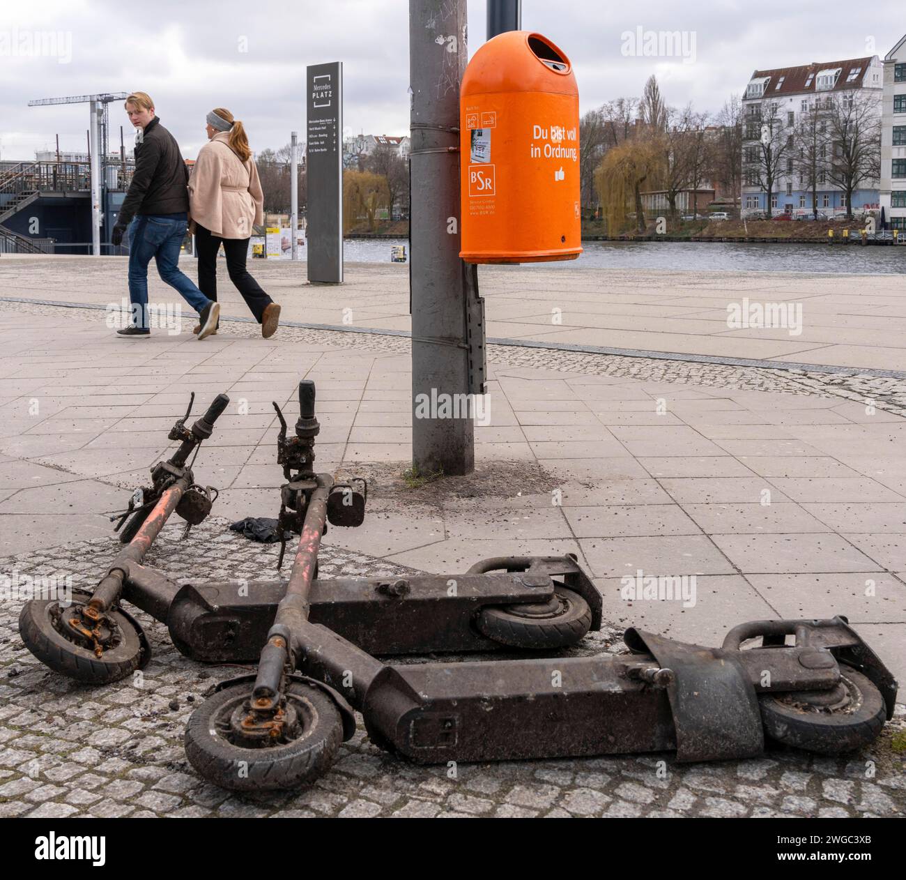 Rusty electric scooters on public streets, East Side Galery in Berlin ...