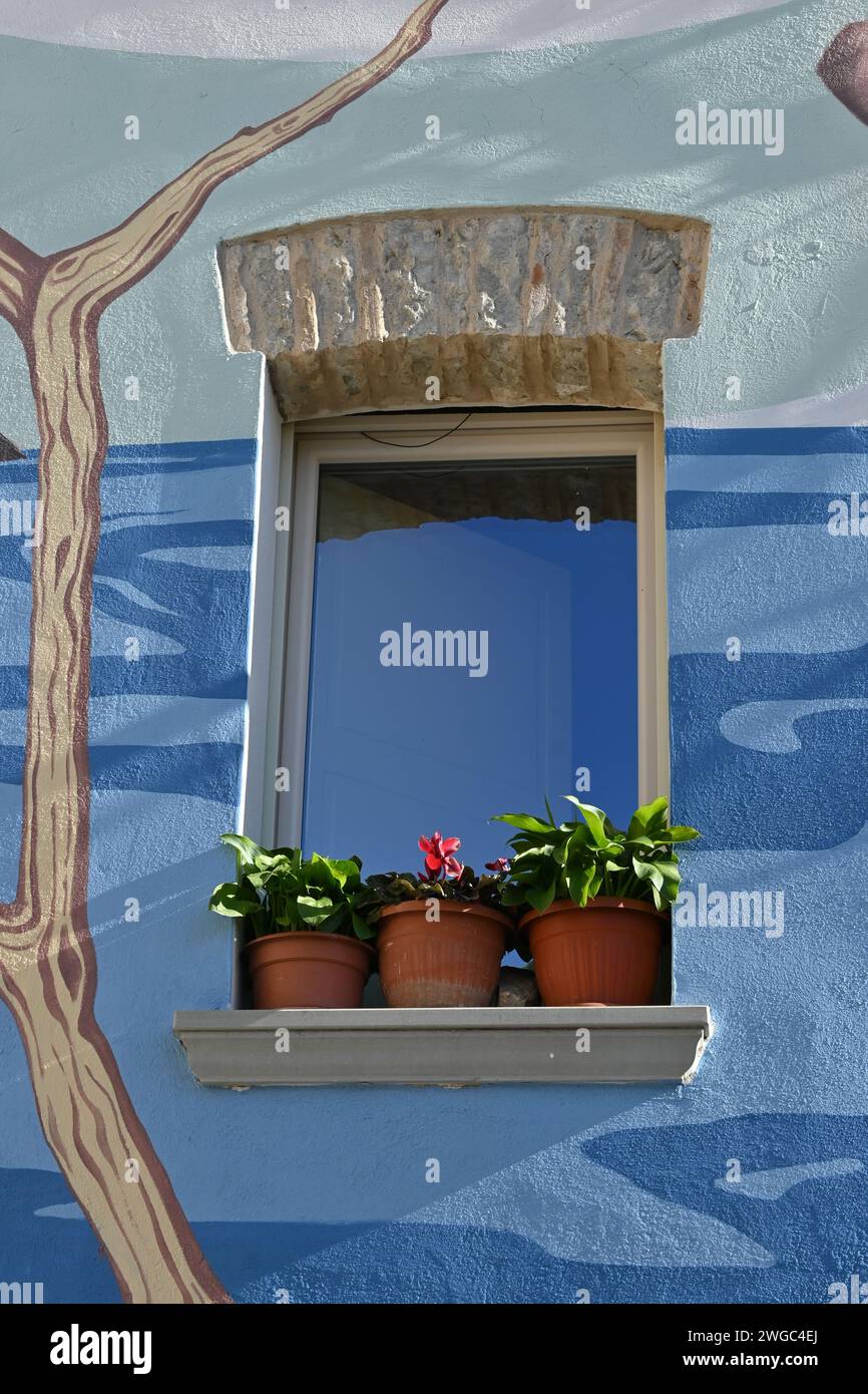 Colored wall and window on the facade of a house in the small town of ...