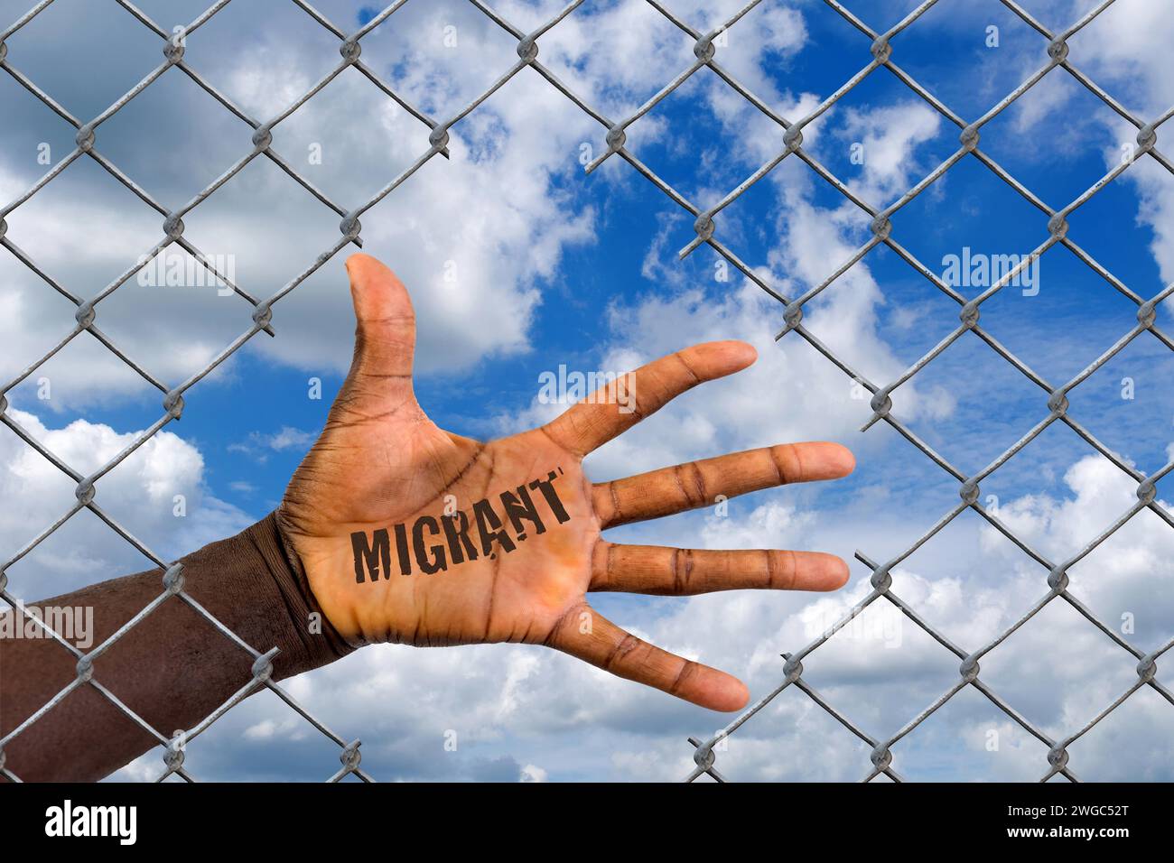 The hand of a foreigner behind a wire mesh fence, hole, loophole, help ...