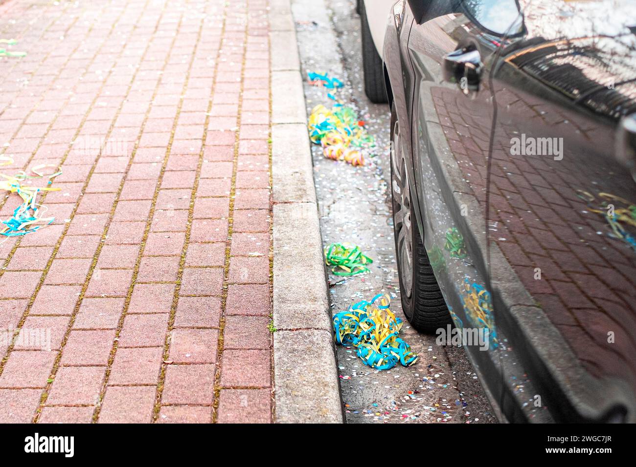 Close up colorful confetti and streamers at the street after Carnival ...