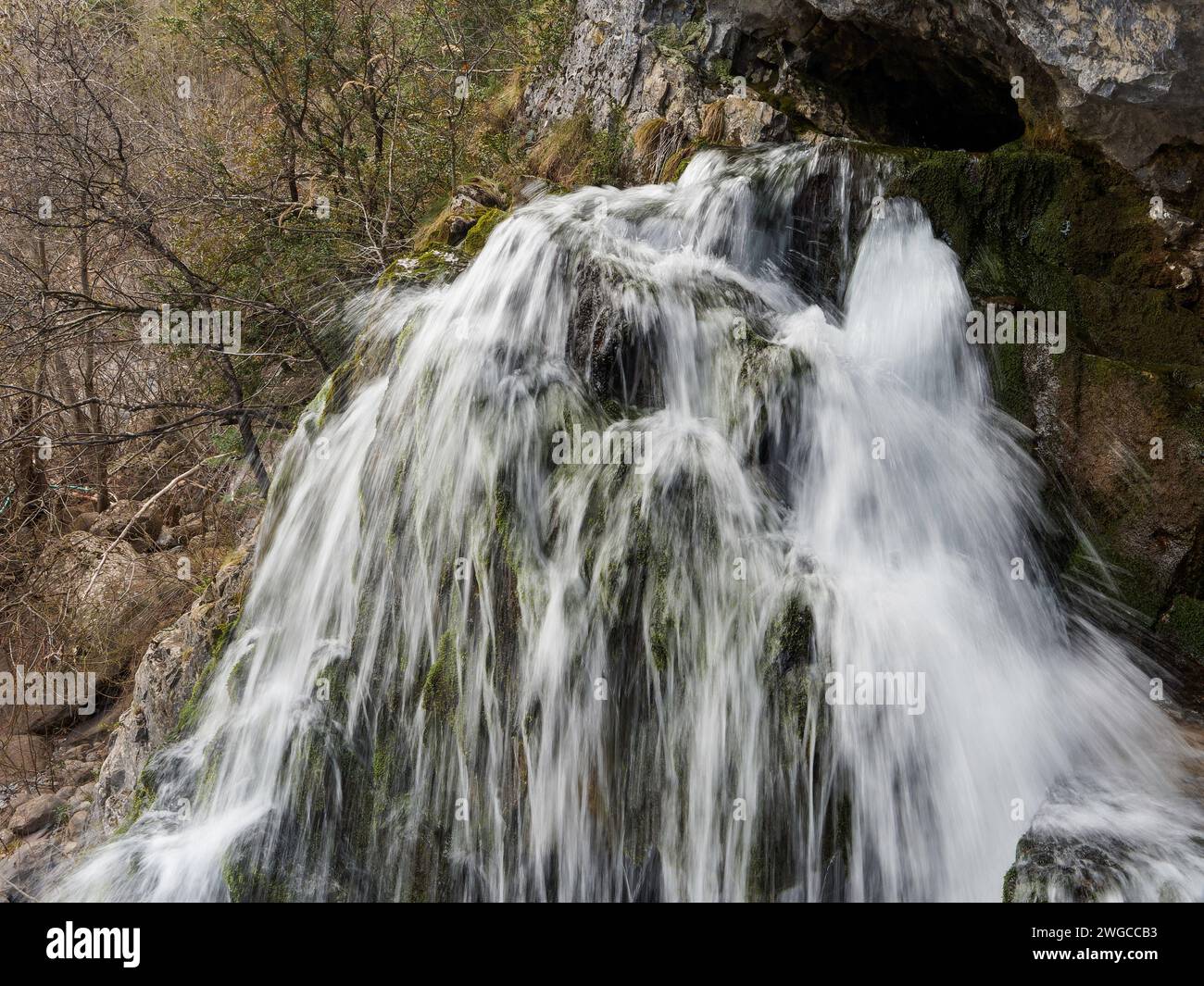 waterfall coming out of the Cueva de Las Güixas, Villanúa, Pyrenees ...