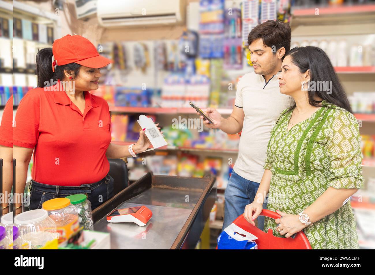 Indian couple at grocery store or supermarket using smart phone for ...