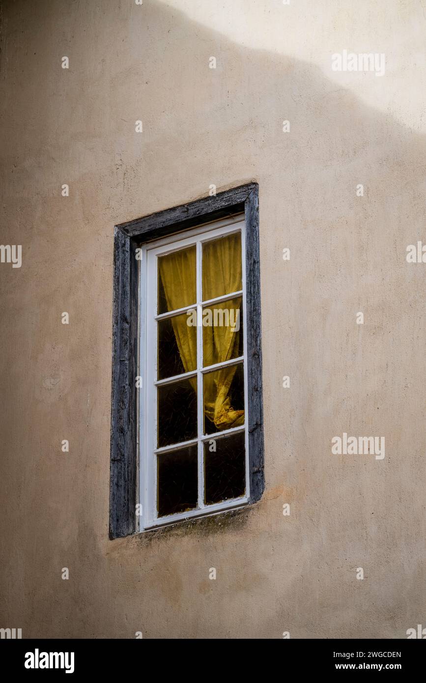 Window with a twisted yellow curtain, Carcassonne, France Stock Photo ...