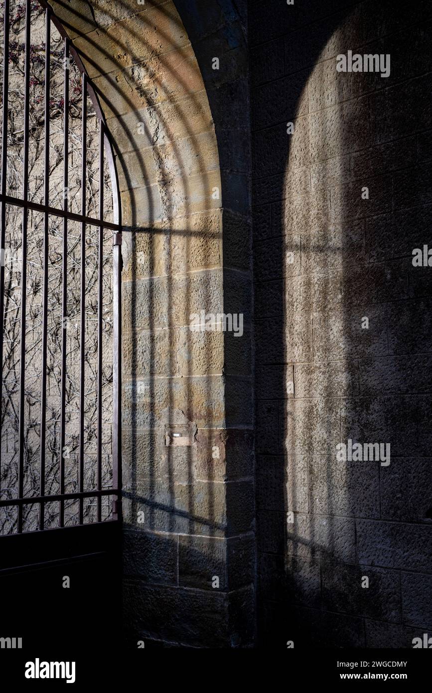 Arch with iron bars and thir shadows in a medieval castle Stock Photo ...