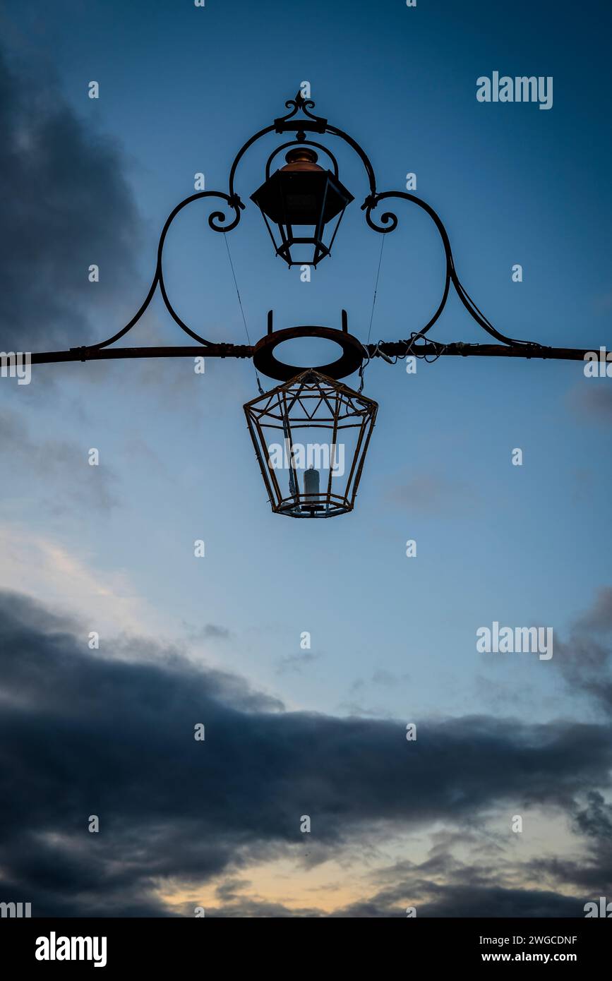 Street lamps on Pont Vieux, the old medieval bridge, at dusk with moody ...