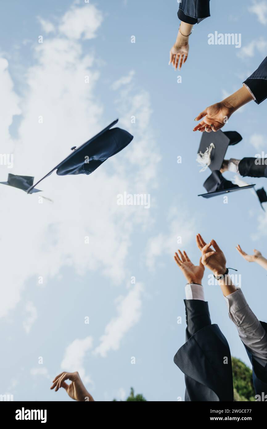 A joyful group of university graduates celebrating their achievements ...